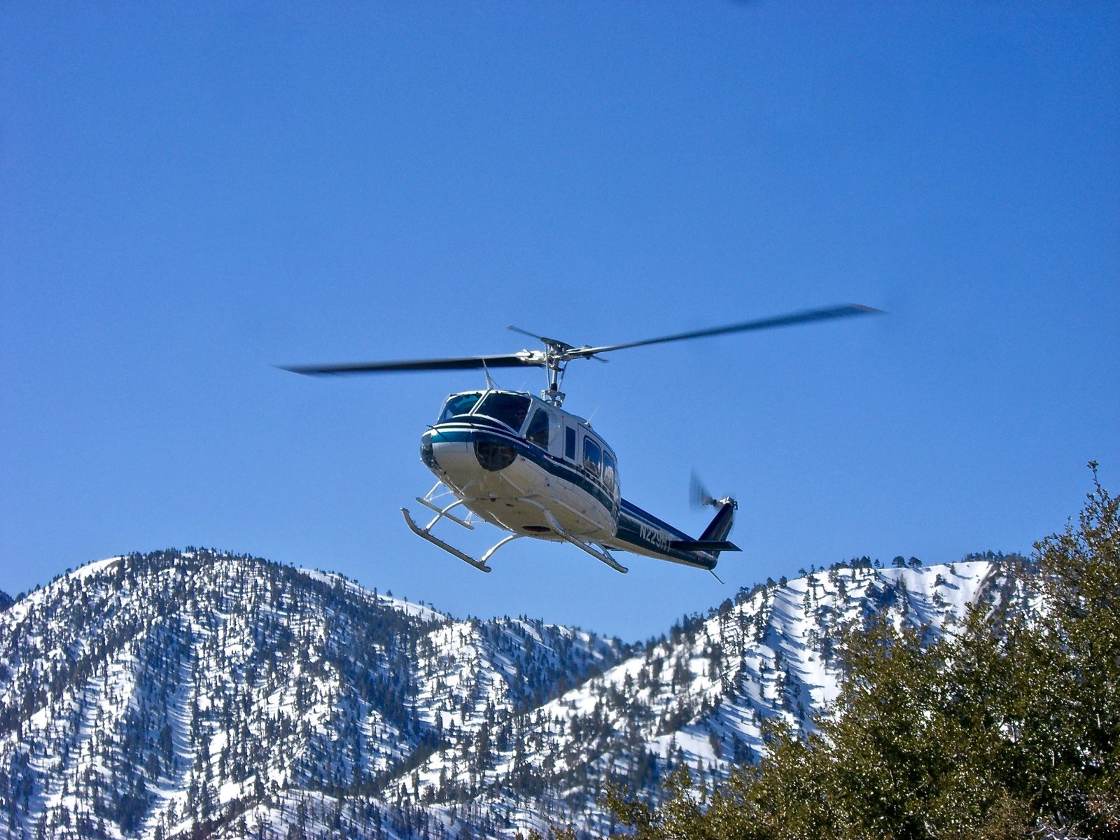 Huey helicopter in the snow - Helistream